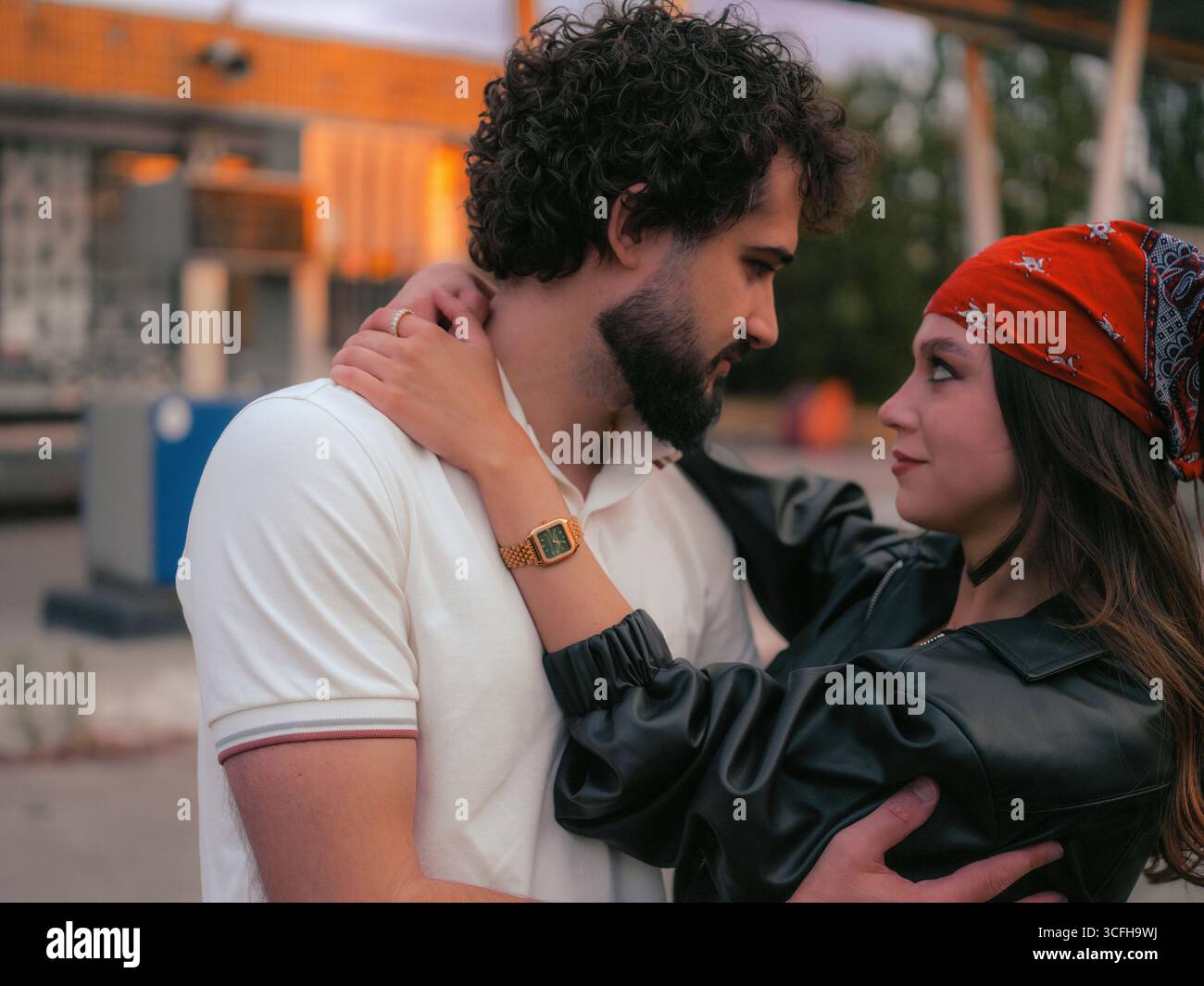 Young couple embracing, looking into each other's eyes. Emotional ...