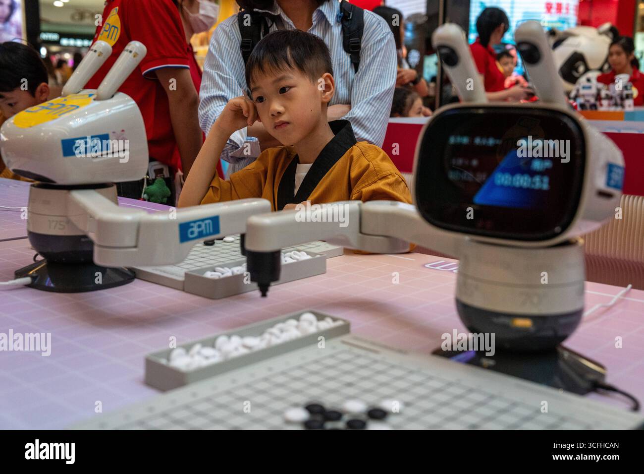 Hong Kong AI Robot Event A boy playing a go game with a robot at an AI ...