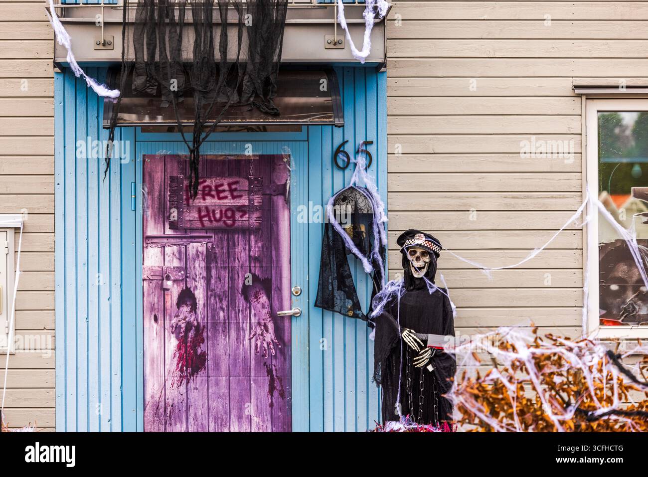 Close up view of Halloween decorated villa entrance with scary skeleton ...