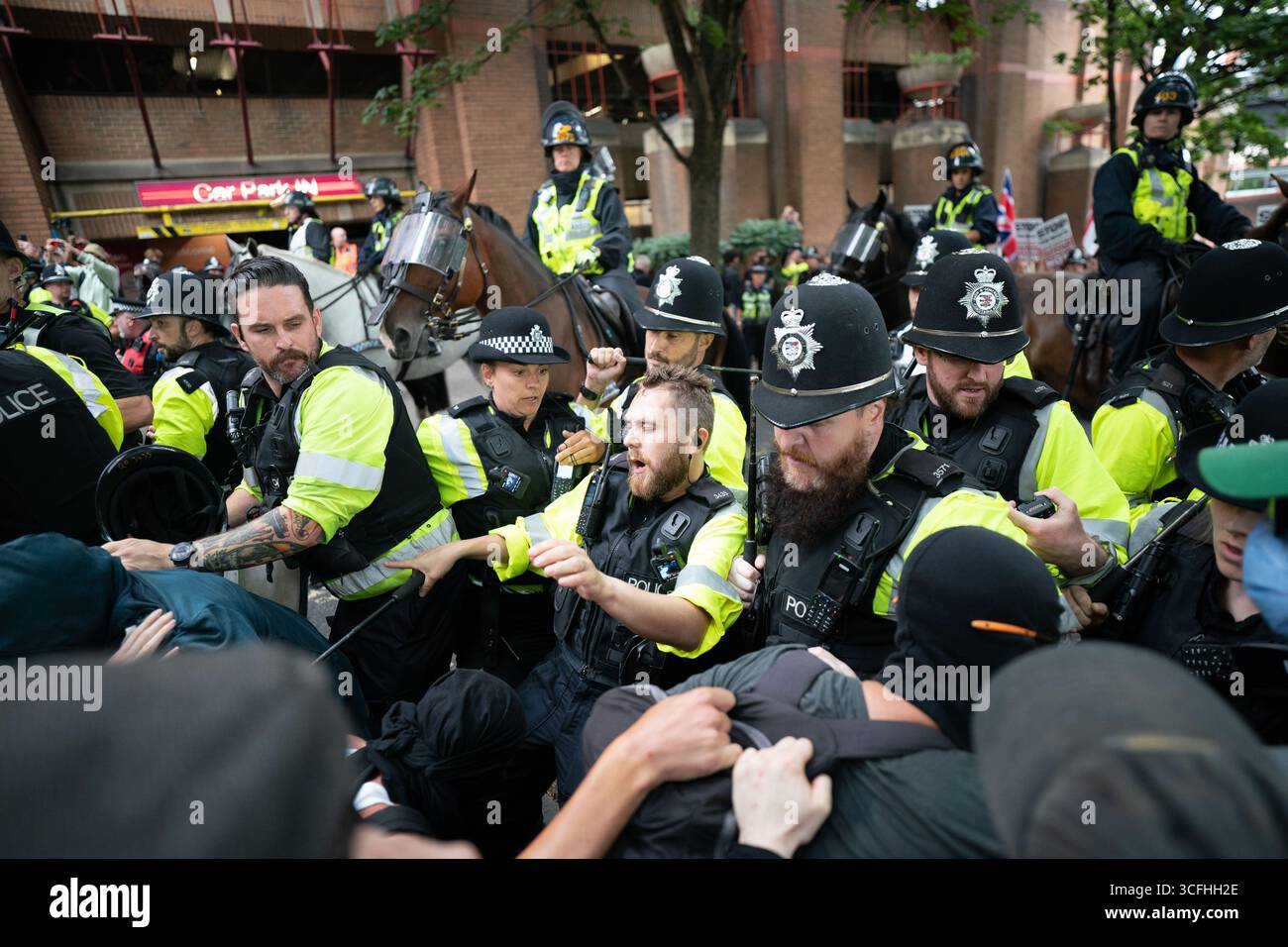 Mounted police officers scuffle with demonstrators during a protest by ...