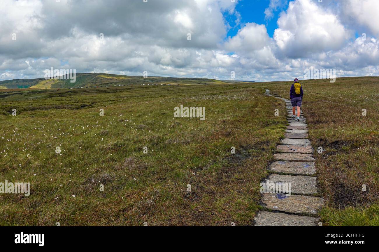 Photo of lone walkers on flagged footpath, Pennine Way, Kinder Scout ...