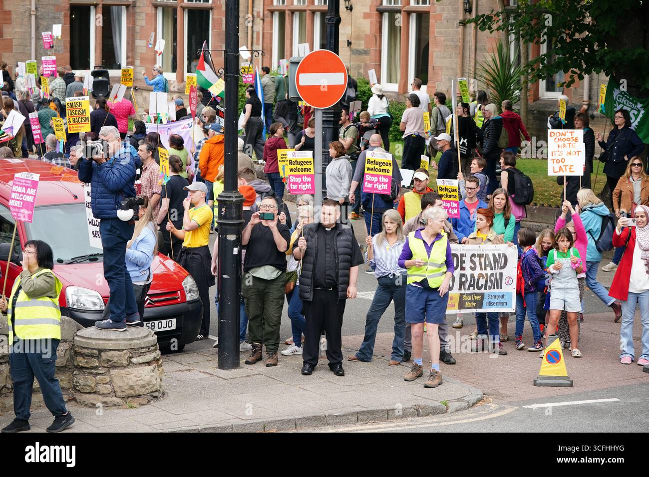 People take part in a counter protest against an Abolish Asylum System ...