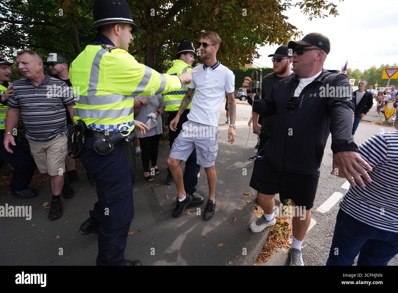 People take part in a counter protest to a Stand Up To Racism rally ...