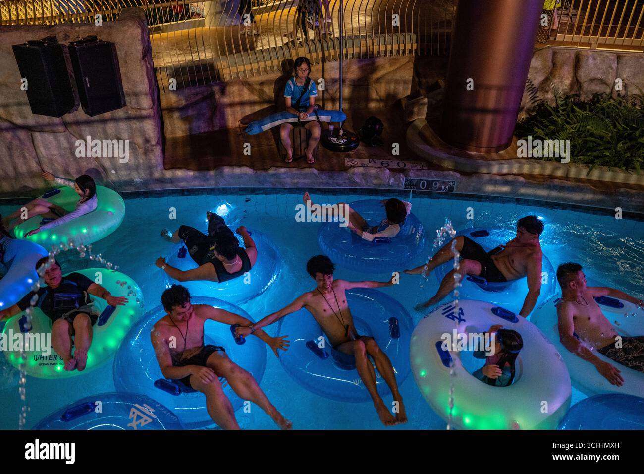 Hong Kong Ocean Park Water World A lifeguard next to people on tube ...