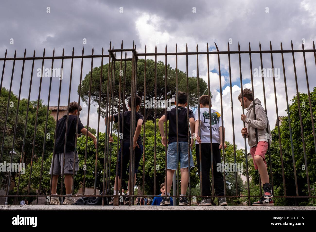 Daily Life in Rome Children playing on the fence at a park on May 10 ...