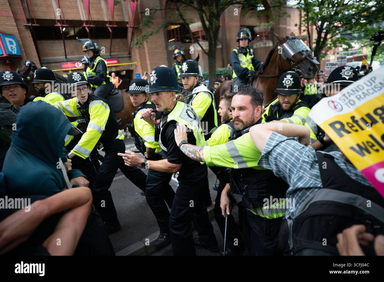Mounted police officers scuffle with demonstrators during a protest by ...