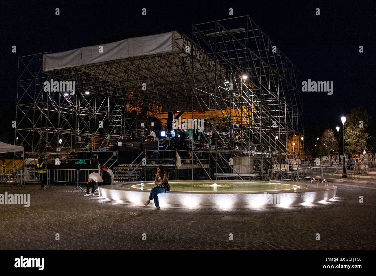 Daily Life in Rome A women sitting next to a pool of water on May 9 ...