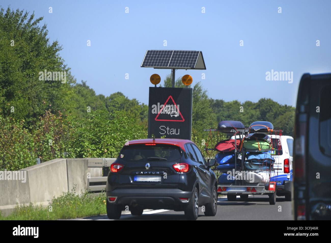 Traffic sign with solar-powered traffic jam warning on the motorway ...