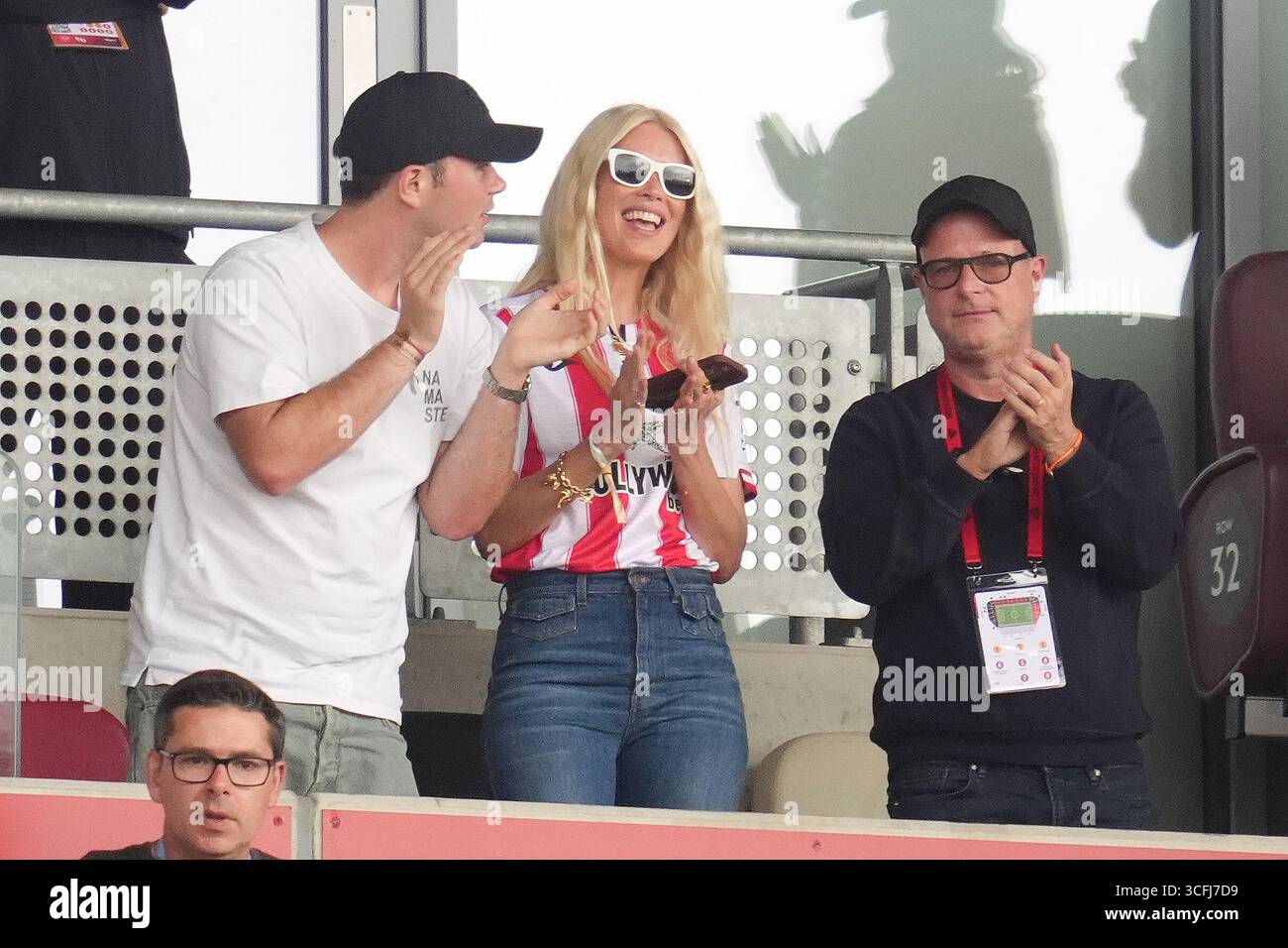 Brentford minority shareholder Sir Matthew Vaughn (right) and Claudia Schiffer (centre) watch on ...