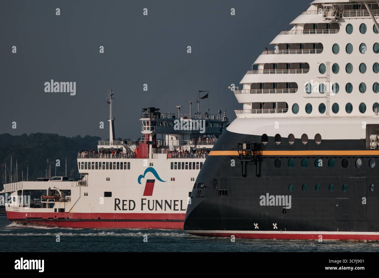 The Disney Cruise ship Fantasy towers over the Red Eagle the Red Funnel ...