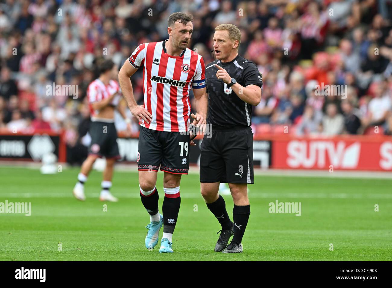 Sheffield United's Jack Robinson and referee John Busby during the Sky ...