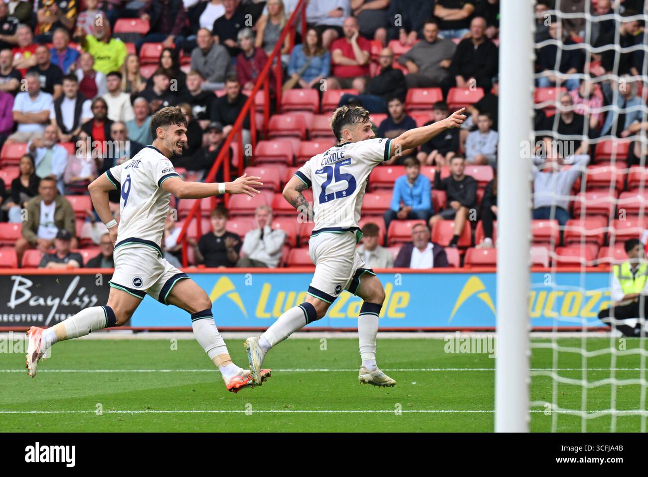 Millwall's Luke Cundle (right) celebrates his sides first goal with ...