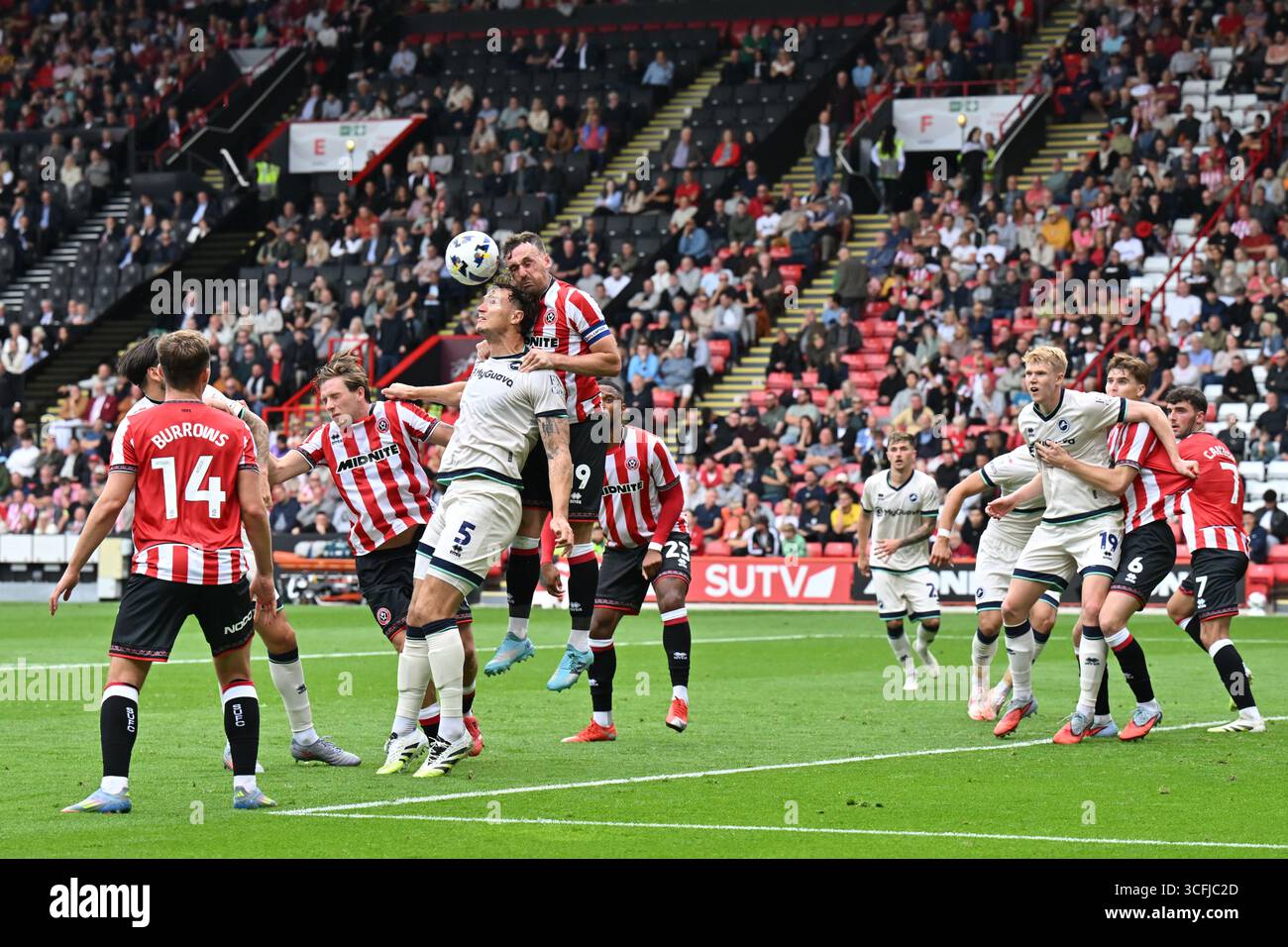 Sheffield United's Jack Robinson (right) beats Millwall's Jake Cooper ...