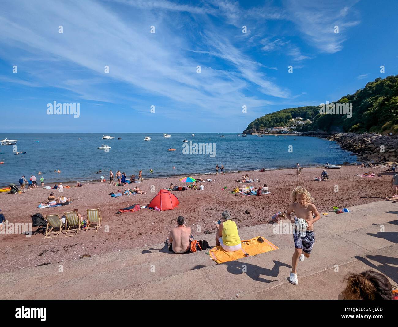 Torquay, UK. 23rd Aug, 2025. Busy beach at Oddicombe in Torquay on a ...