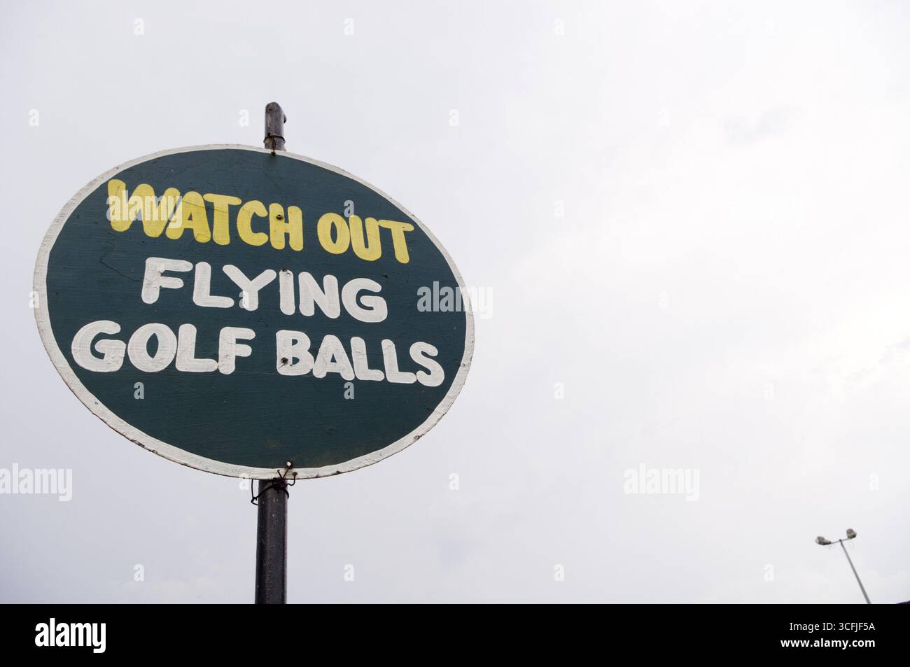 Handwritten sign in golf field, warning of flying golf balls Stock ...
