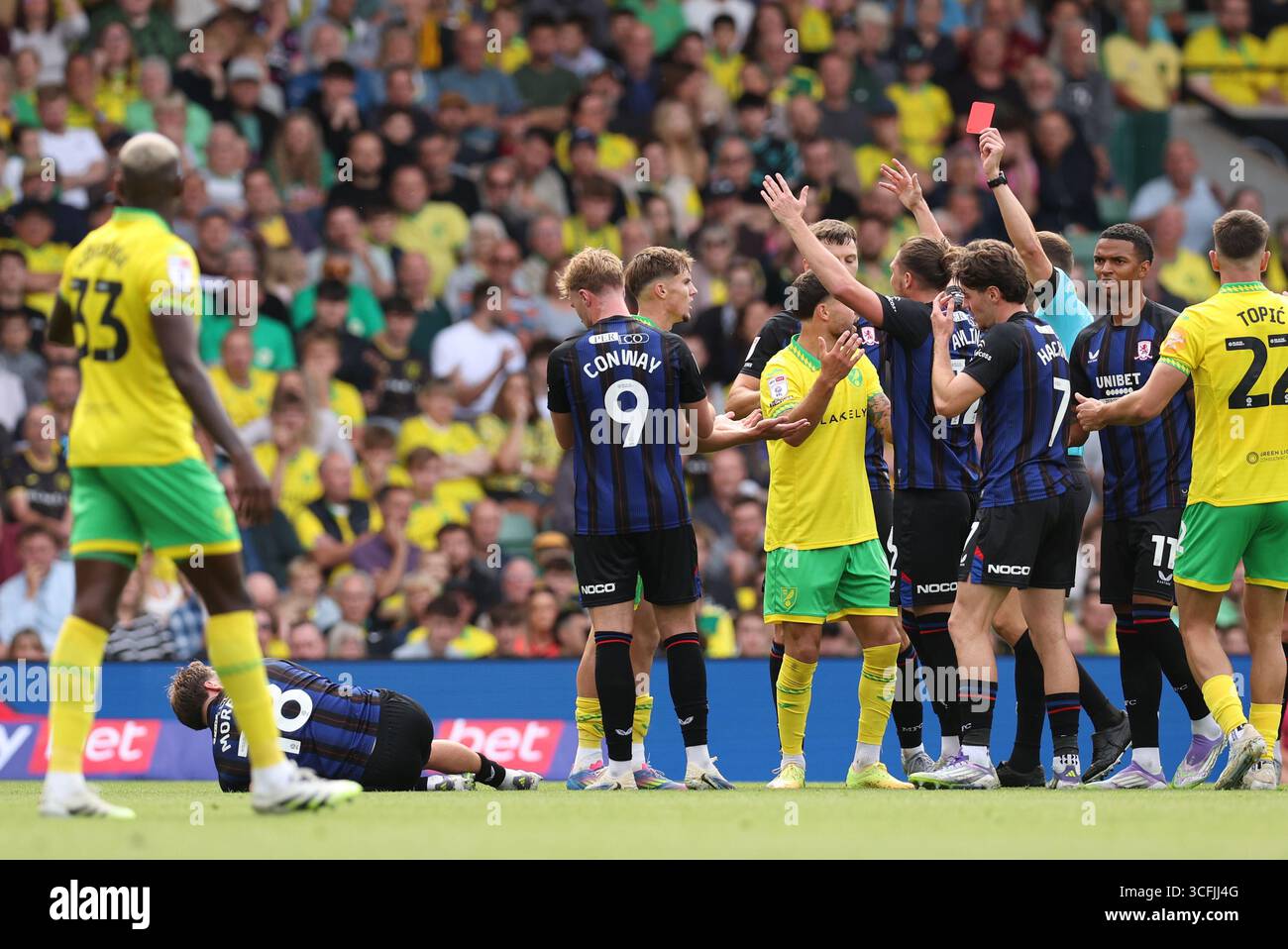 Norwich City's Jacob Wright (obscured) is shown a red card by referee ...