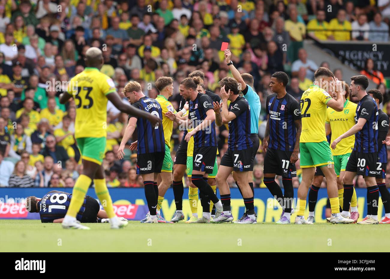 Norwich City's Jacob Wright (obscured) is shown a red card by referee ...