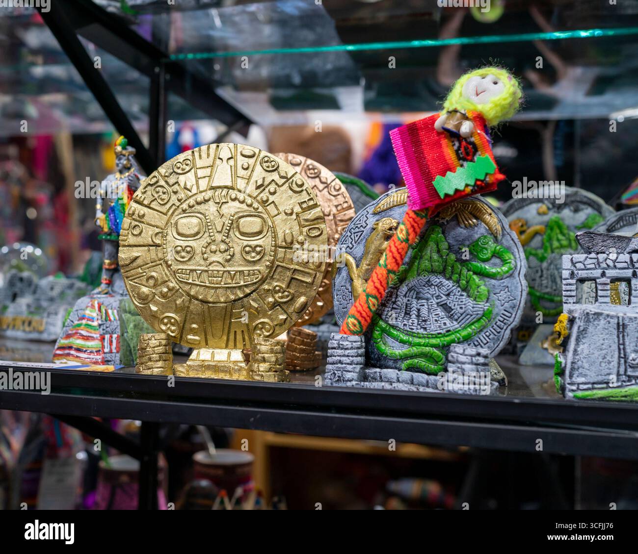 Colorful Peruvian souvenirs featuring Inca sun symbols, handmade crafts ...