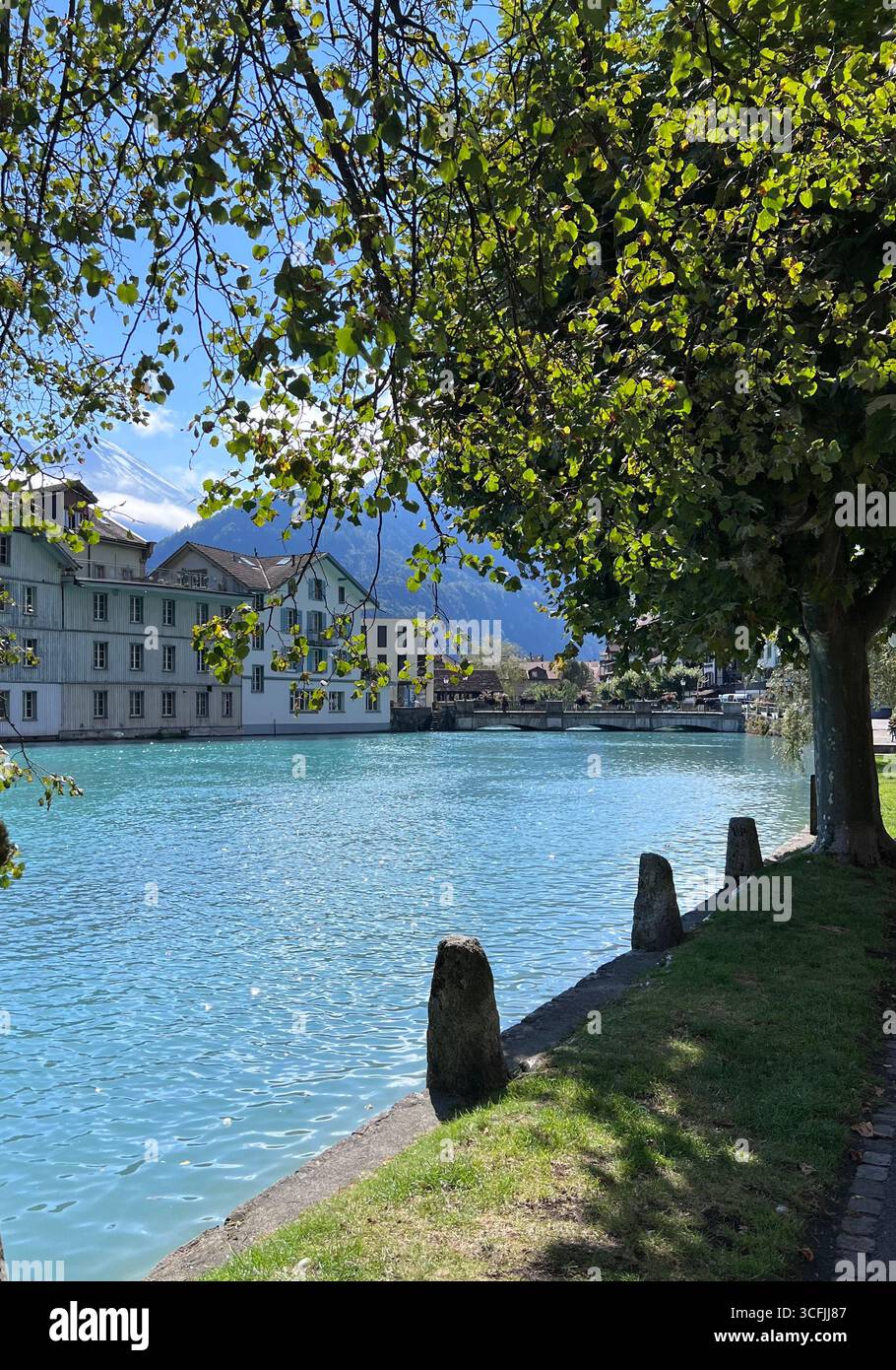 Scenic view of the turquoise Aare River with traditional Swiss houses ...