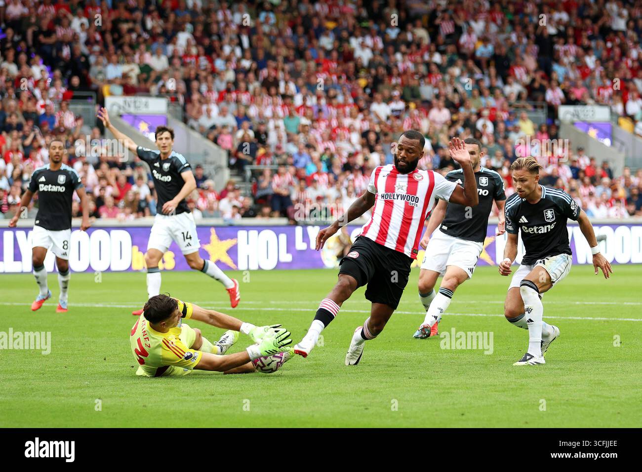 Aston Villa goalkeeper Emiliano Martinez (centre left) saves at the ...