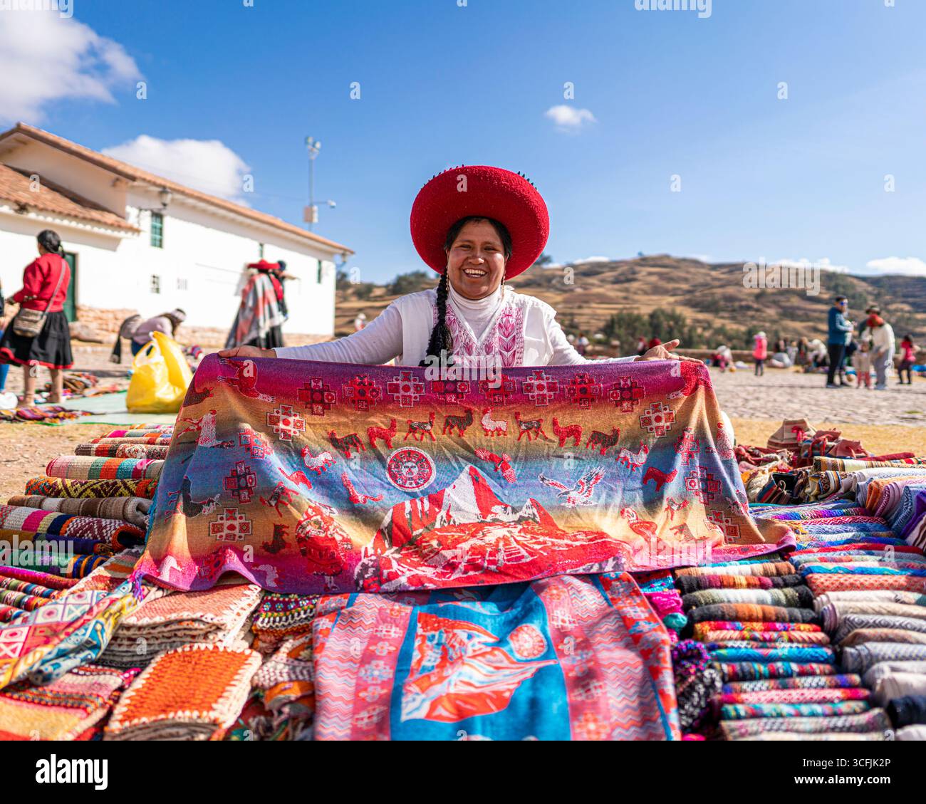 Andean woman selling colorful traditional textiles in a craft market in ...