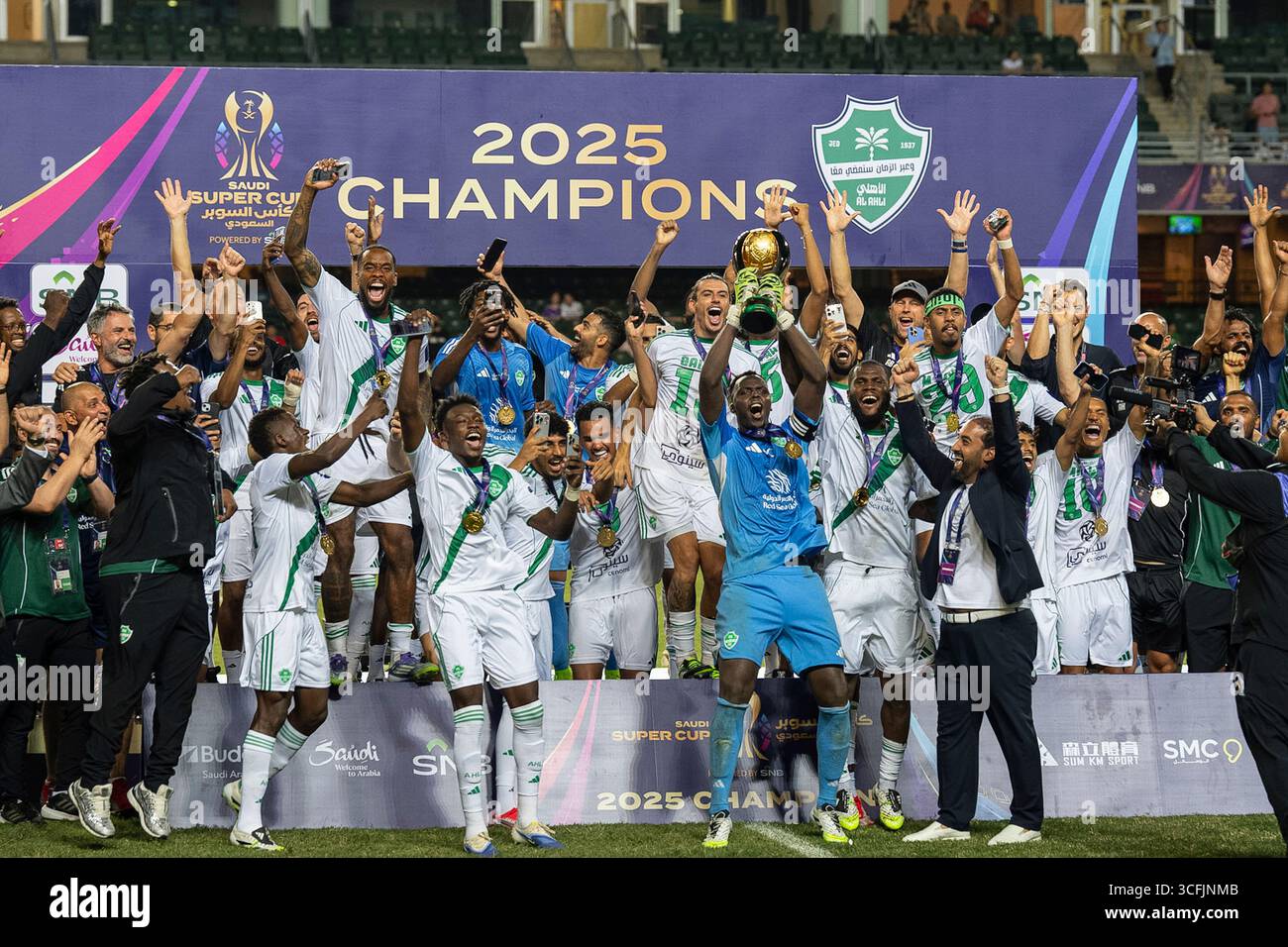 Al Ahli's players celebrate with their trophy after winning the Saudi ...