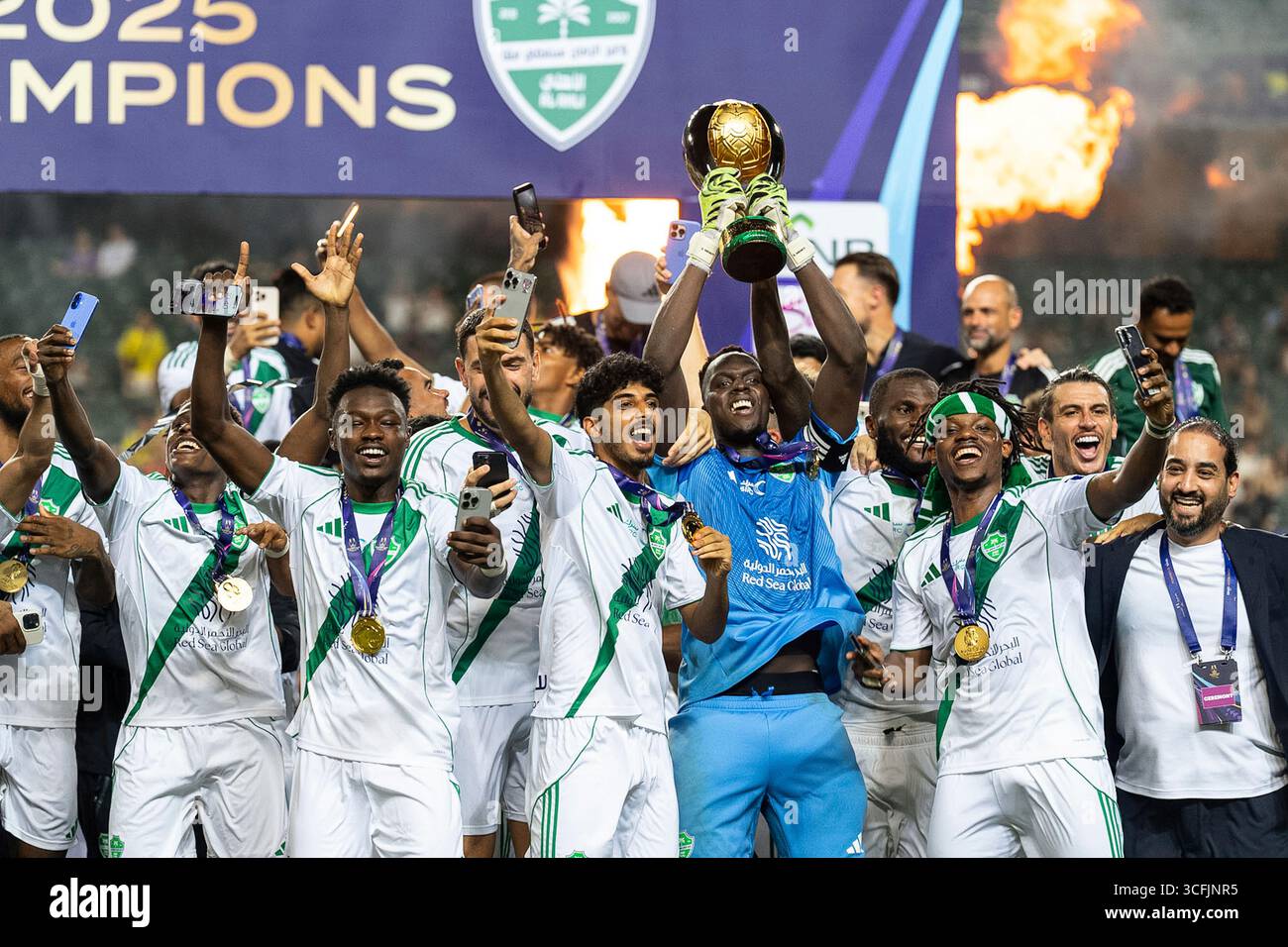 Al Ahli's players celebrate with their trophy after winning the Saudi ...