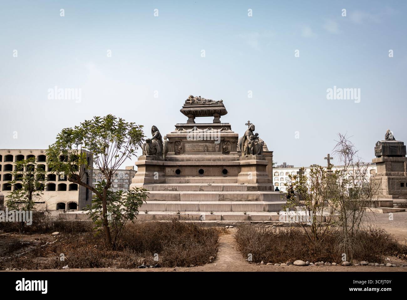 Large historic funerary monument with sculpted figures and stepped base ...