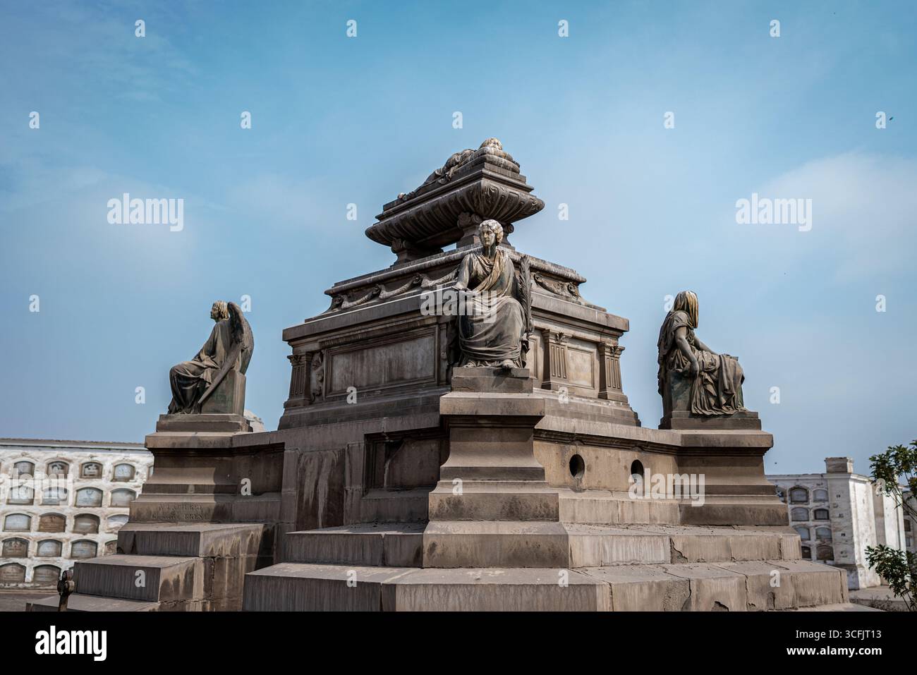 Large funerary monument with seated stone figures and stepped base at ...