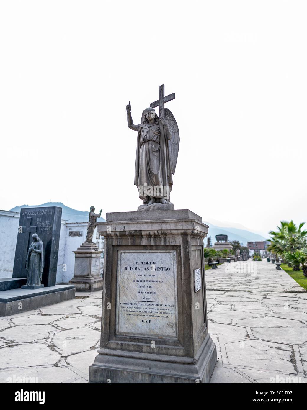 Angel statue holding a cross at the tomb of Presbitero Matias Maestro ...