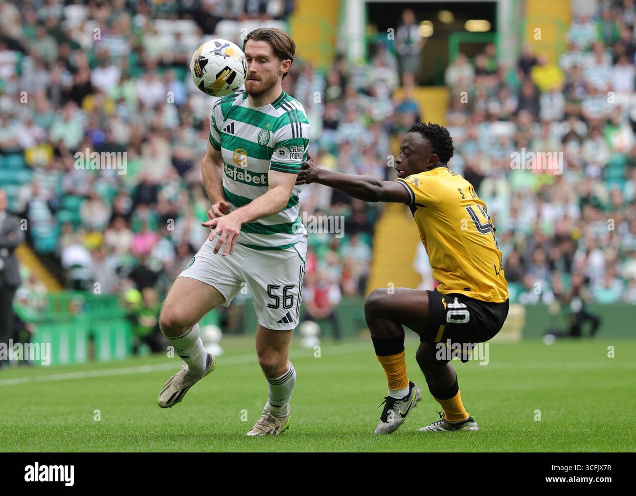 Celtic's Anthony Ralston (left) and Livingston's Samson Lawal battle ...