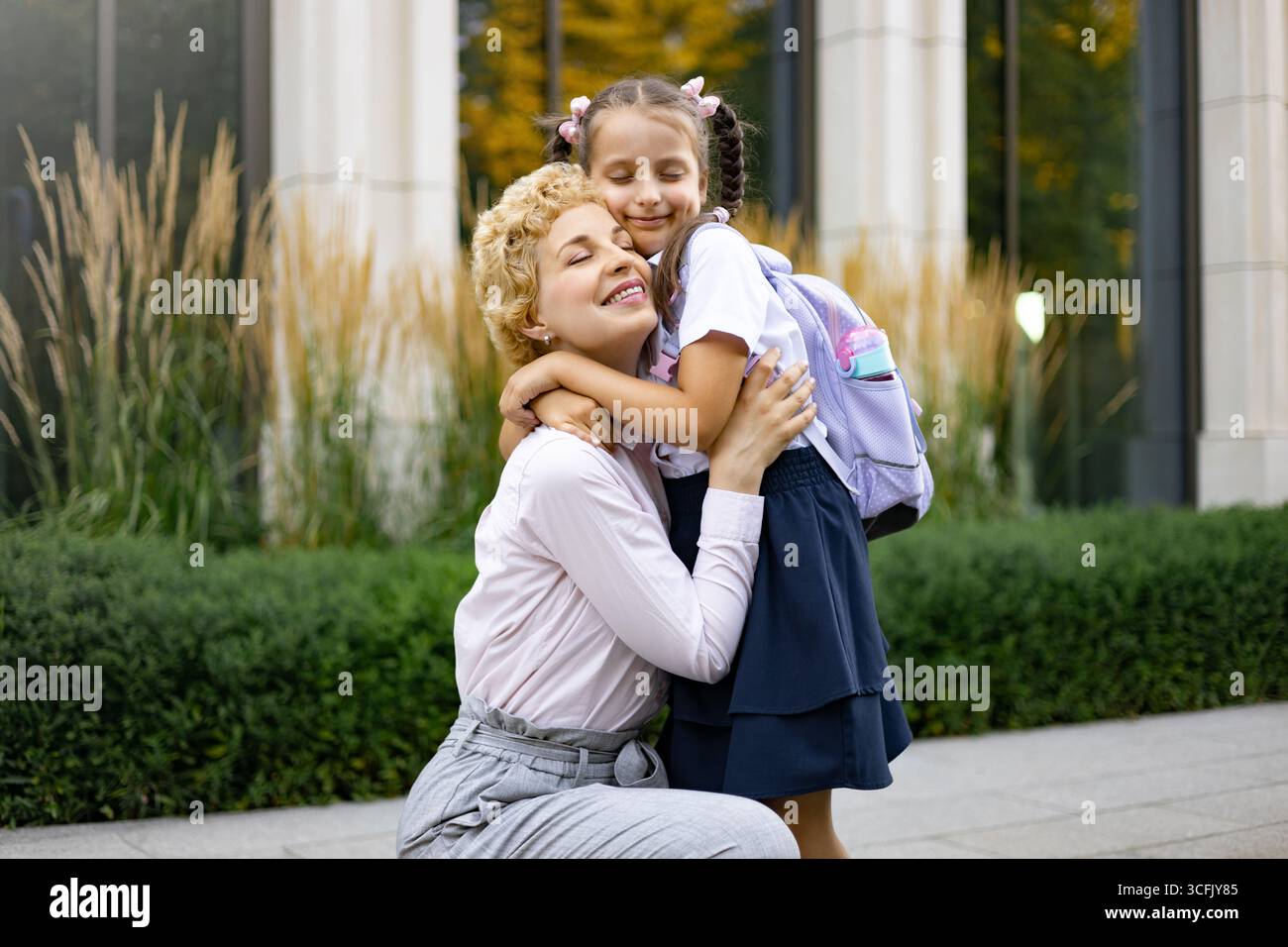 Mother hugging daughter backpack hi-res stock photography and images ...
