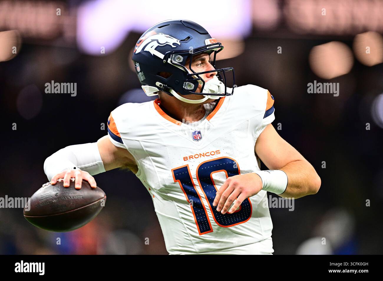 Denver Broncos quarterback Bo Nix warms up before facing the New ...
