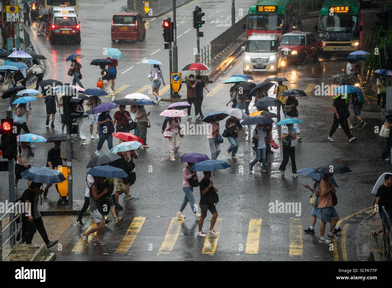 Hong Kong Observatory issues Amber Rainstorm Warning People holding ...