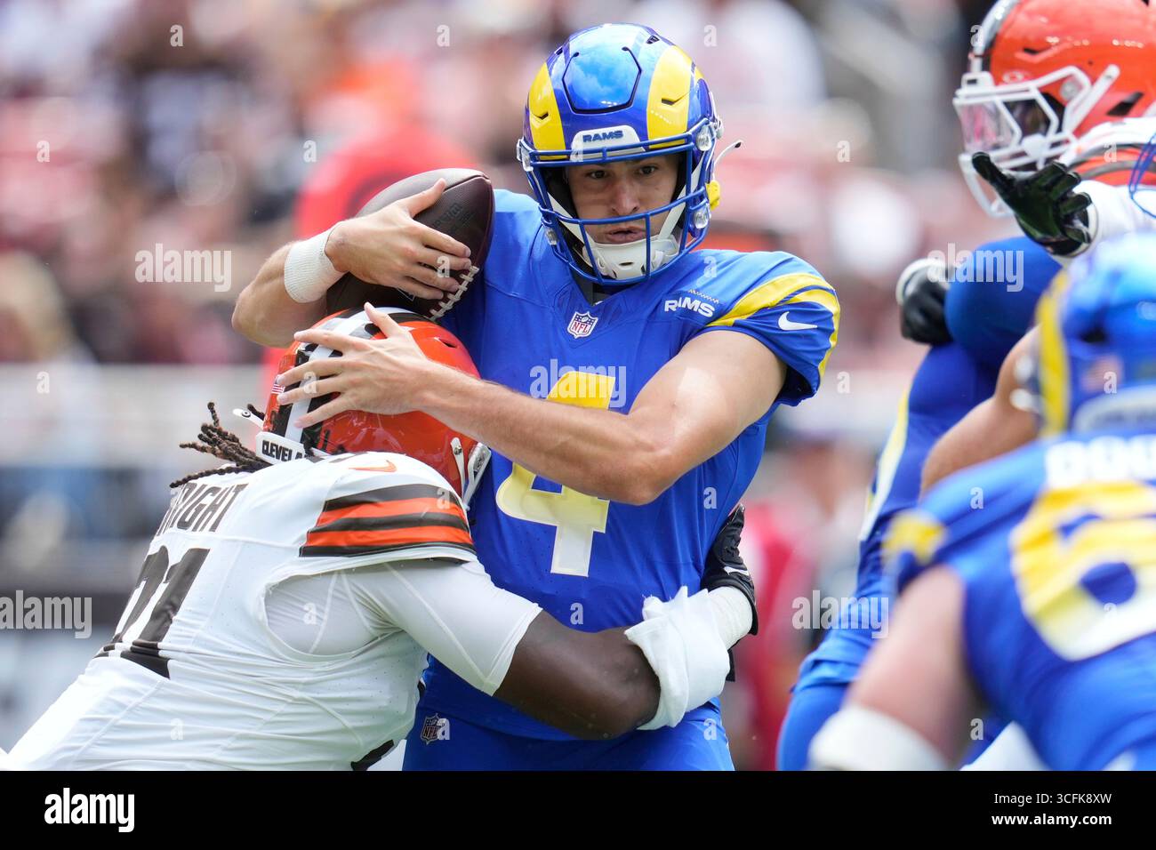 Los Angeles Rams quarterback Dresser Winn (4) is sacked by Cleveland ...
