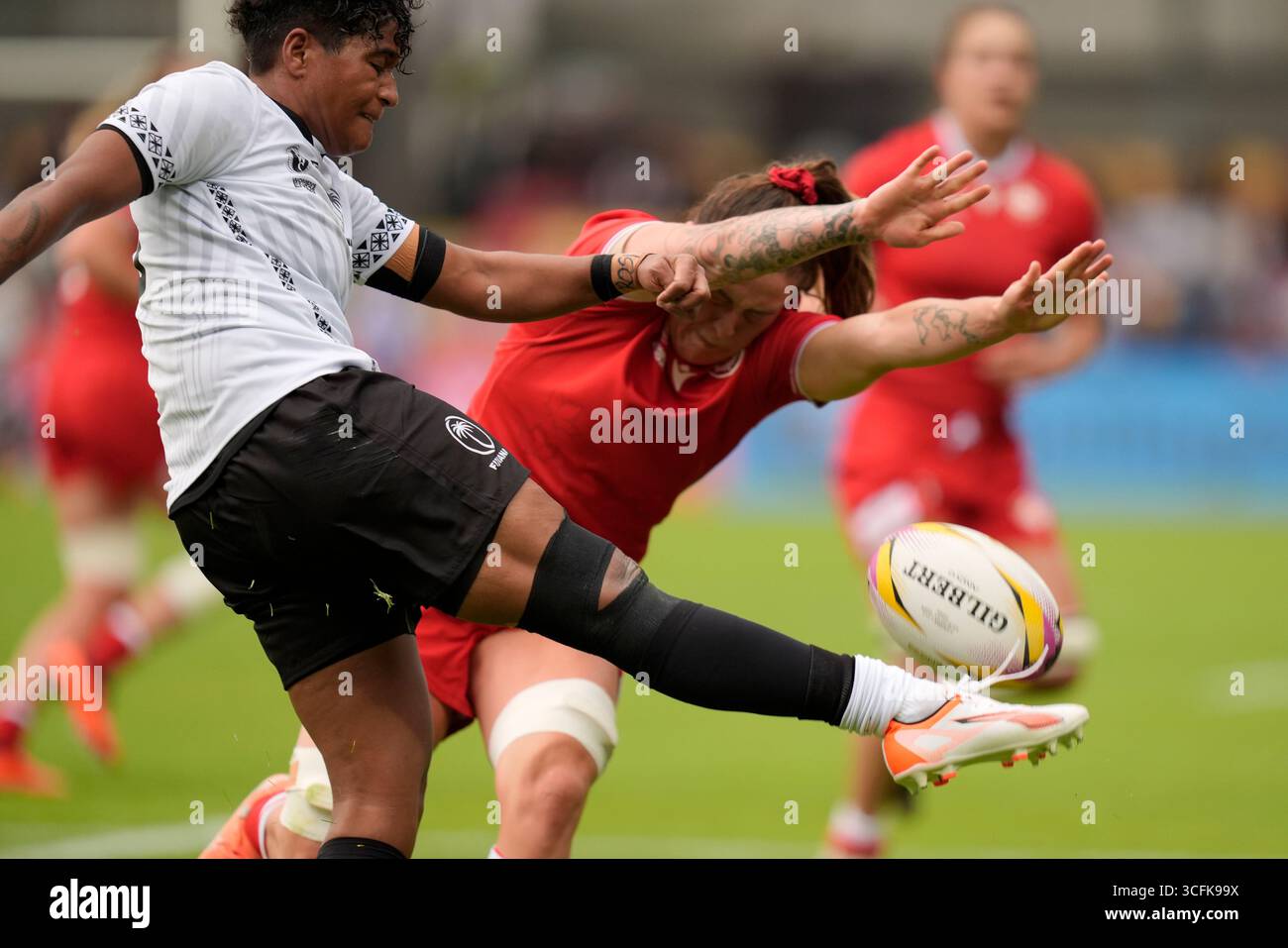 Canada's Gabrielle Senft attempts to bloke a kick from Fiji's Litiana ...