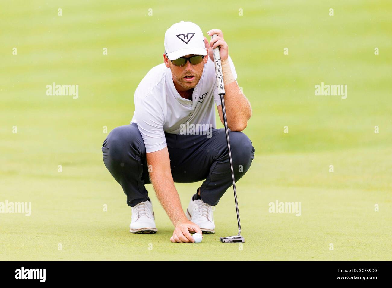 Andy Ogletree of HyFlyers GC lines up a putt on the ninth green during ...