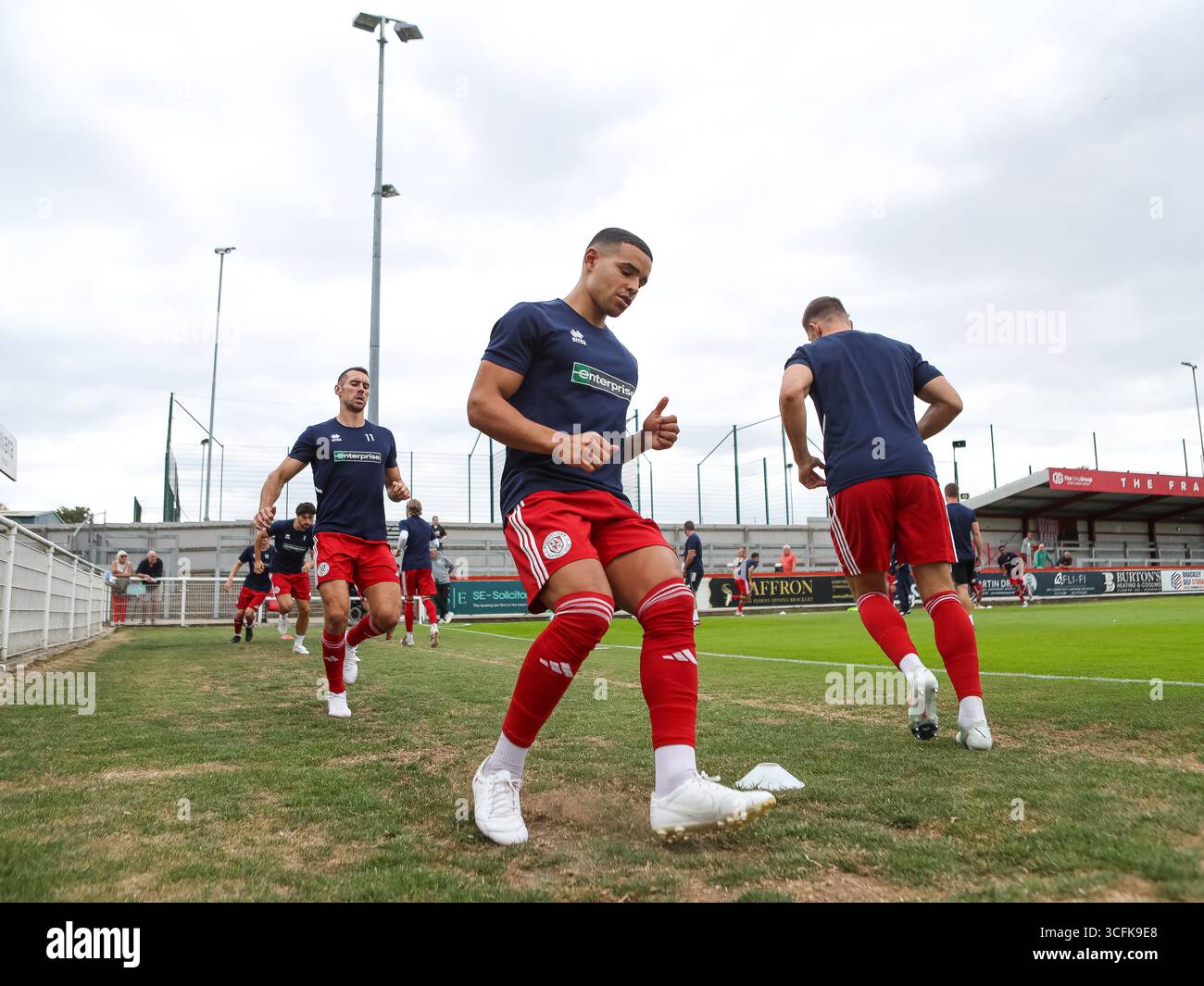 Brackley, UK. 23rd August 2025. Tyler Lyttle of Brackley Town warms up ...