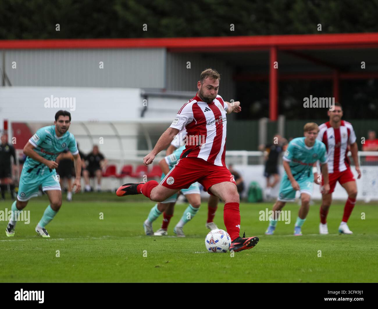 Brackley, UK. 23rd August 2025. Connor Hall of Brackley Town takes a ...