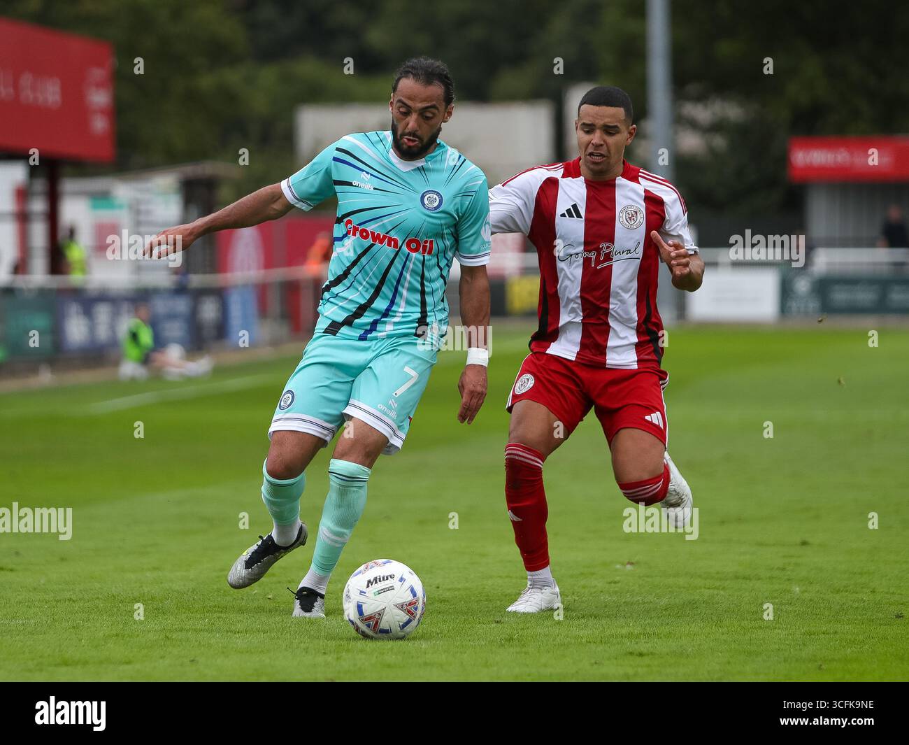 Brackley, UK. 23rd August 2025. Tyler Lyttle of Brackley Town battles ...