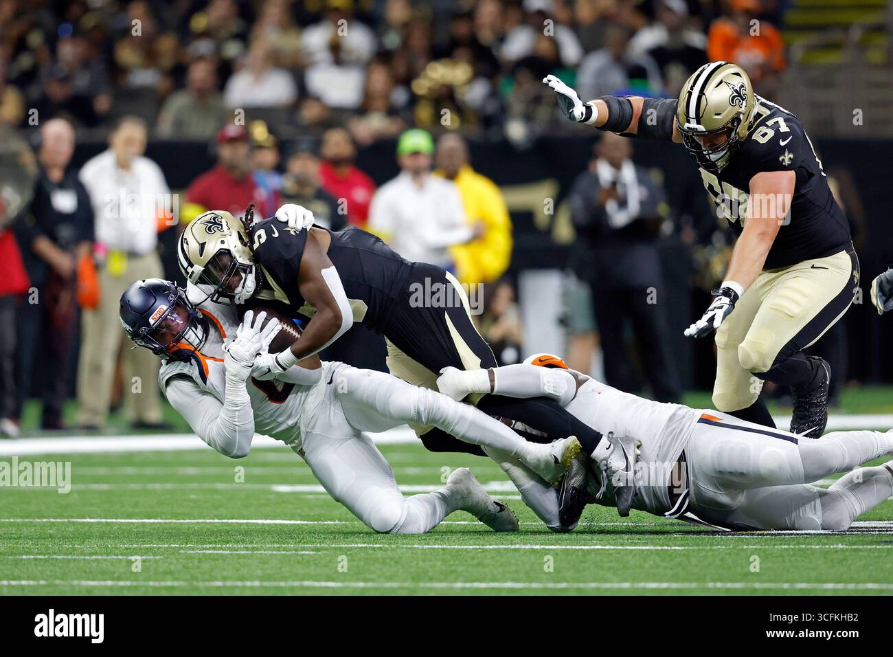New Orleans Saints running back Kendre Miller (5) is tackled by Denver ...