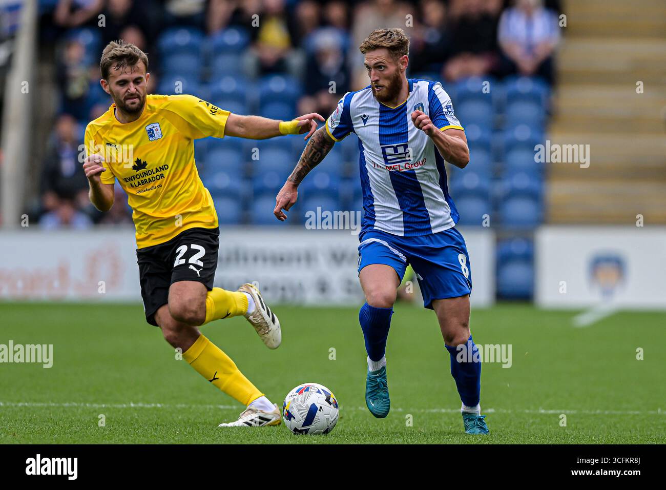 Teddy Bishop (8 Colchester United) challenged by Regan Booty (22 Barrow ...