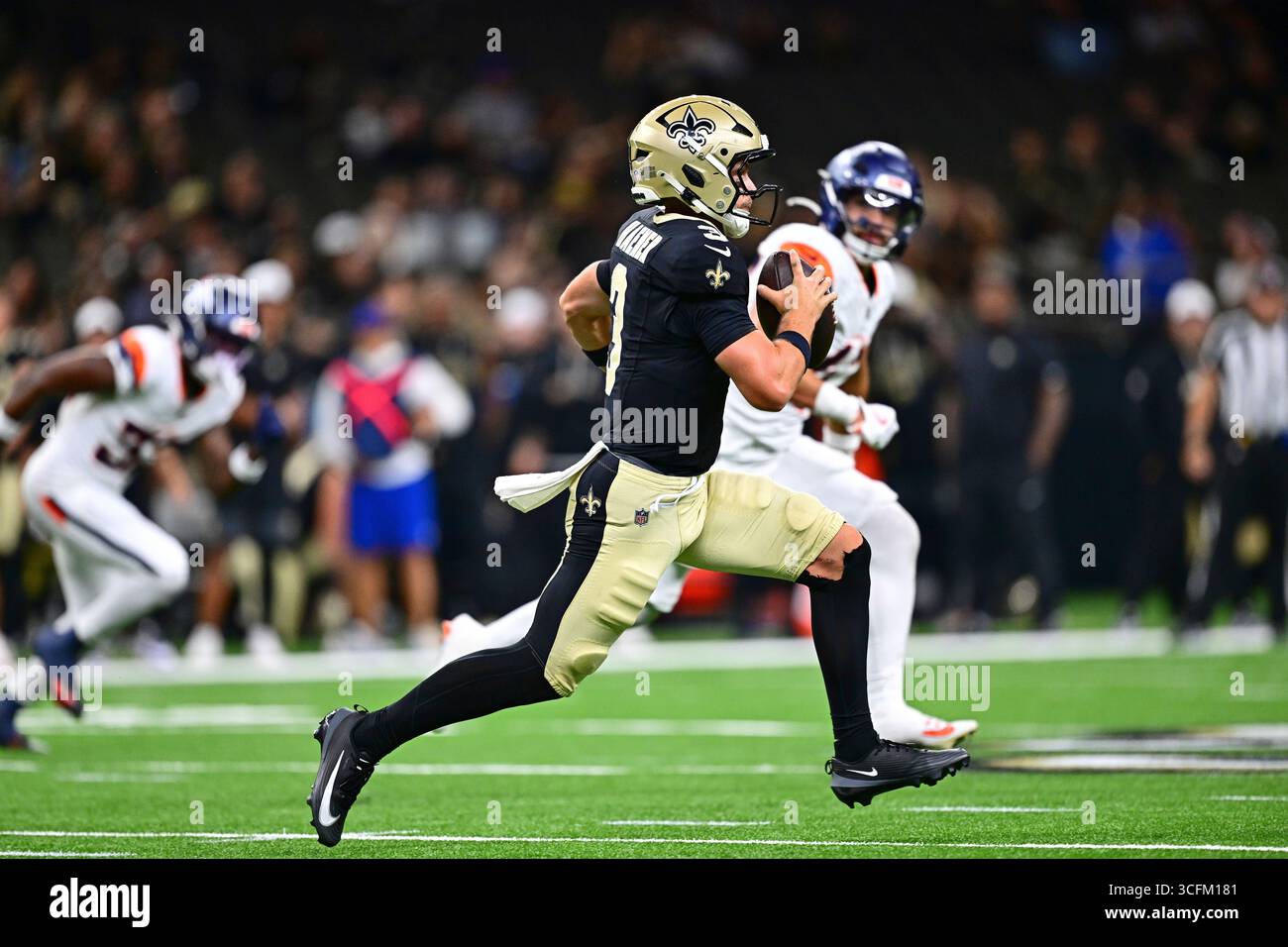 New Orleans Saints quarterback Jake Haener runs for a short gain in the ...