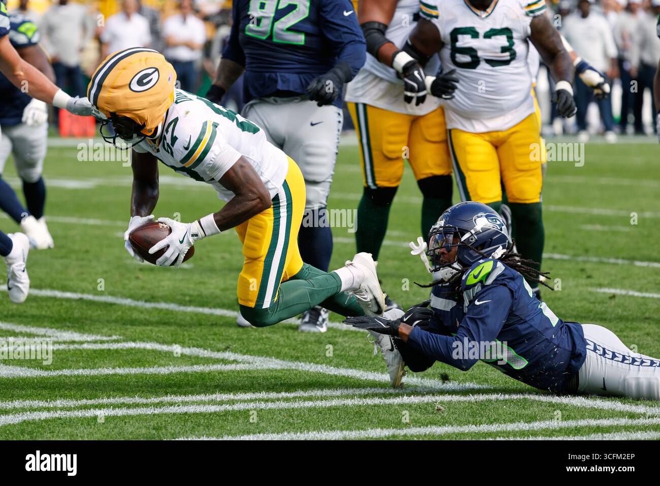 Green Bay Packers' Romeo Doubs catches a touchdown pass in front of ...
