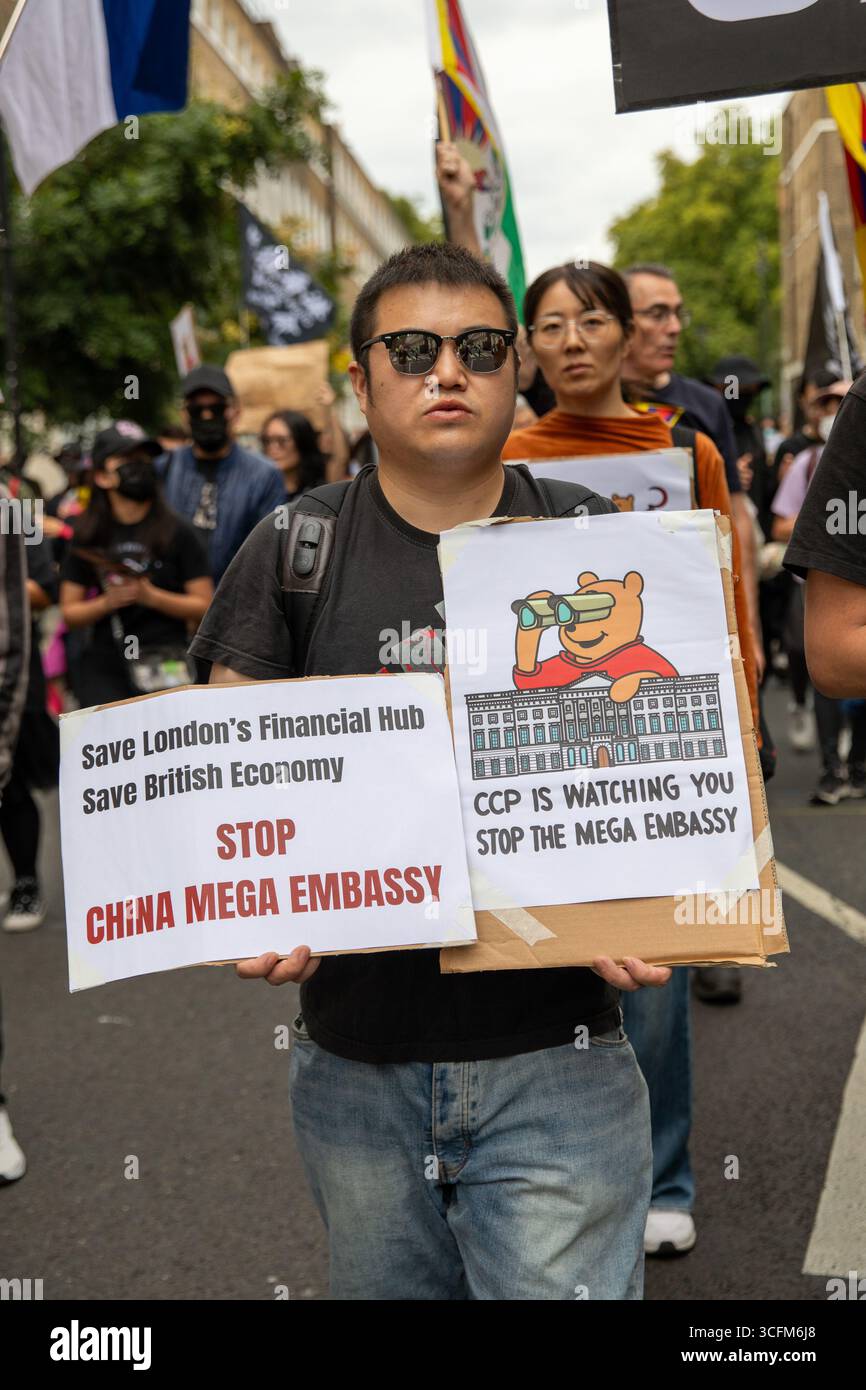 An anti CCP activist holds placards during a demonstration. Hong Kong ...