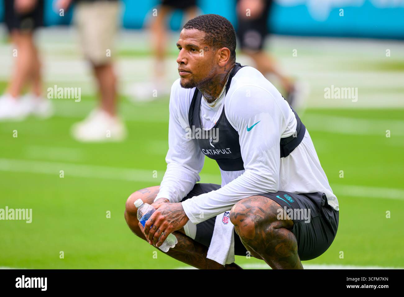 Miami Dolphins tight end Darren Waller squats on the field before an ...