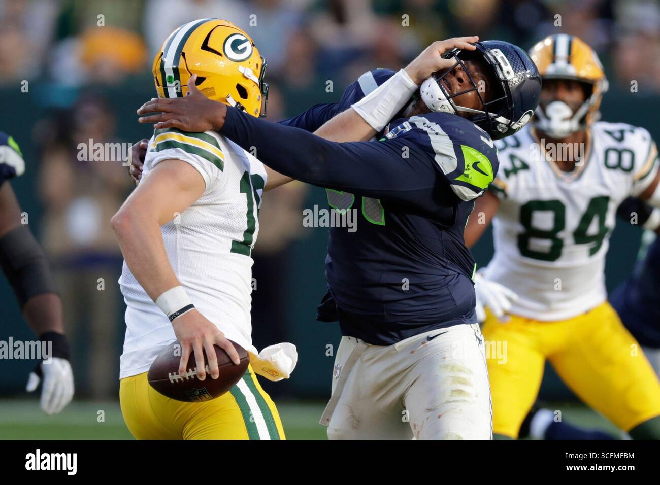 Green Bay Packers' Taylor Elgersma stiff arms Seattle Seahawks' Jared ...