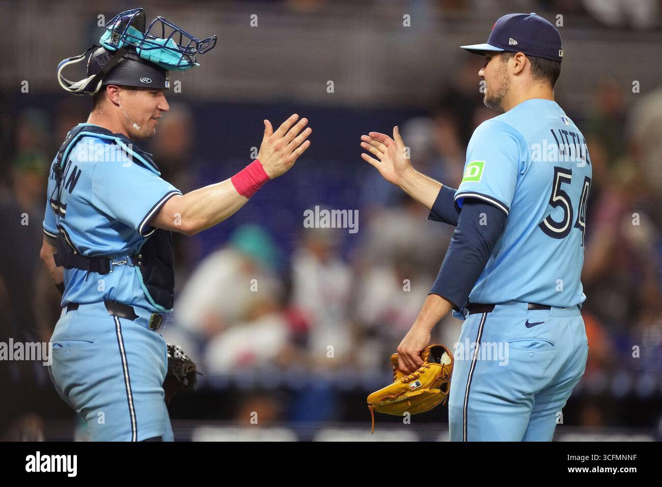 Toronto Blue Jays' Tyler Heineman, left, congratulates relief pitcher ...