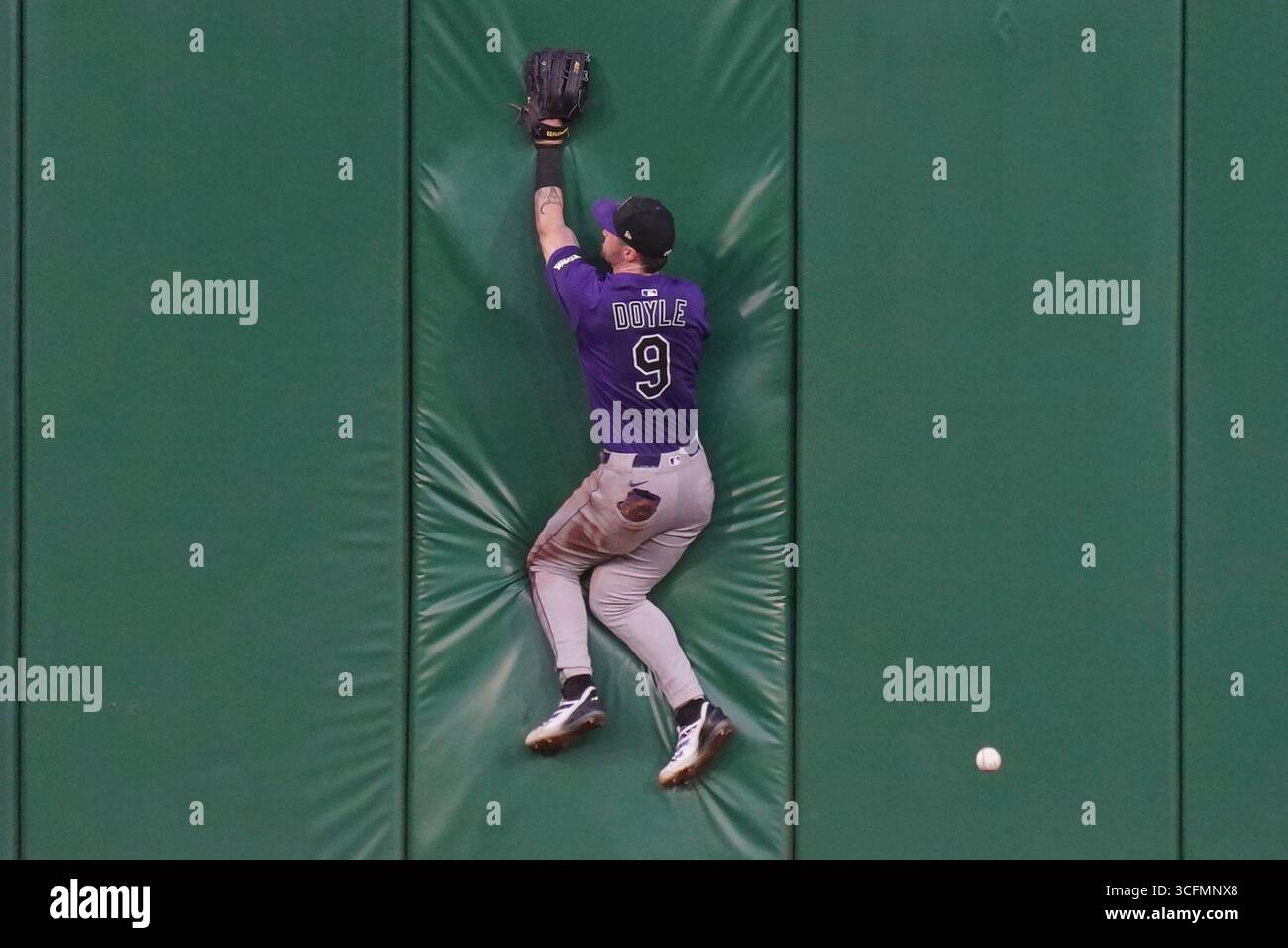 Colorado Rockies center fielder Brenton Doyle hits the wall while ...