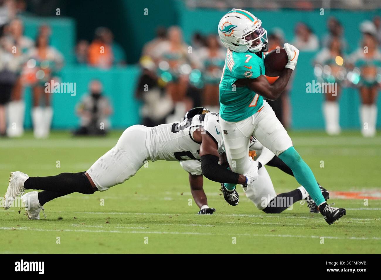 Jacksonville Jaguars safety Rayuan Lane III (25) tackles Miami Dolphins ...
